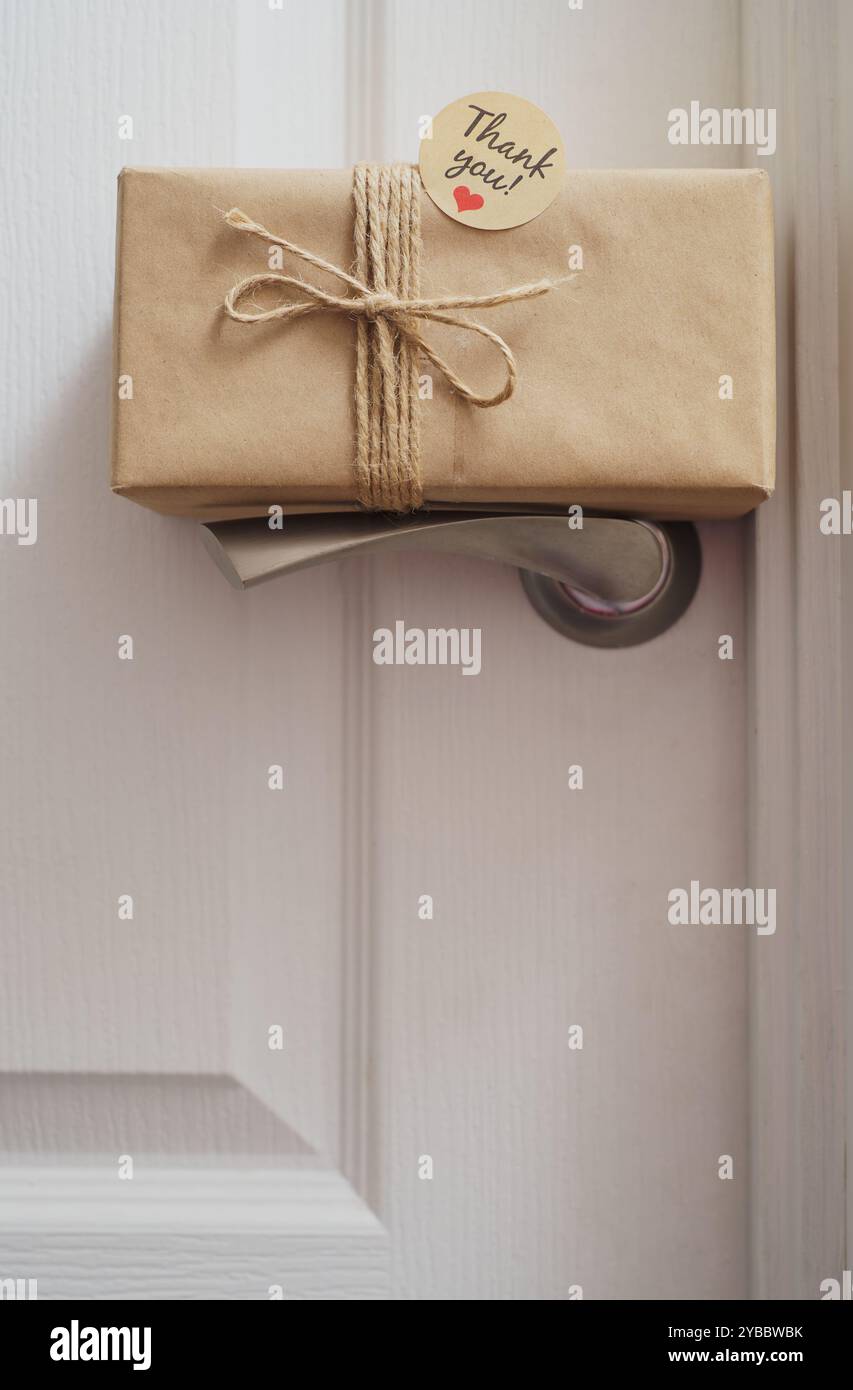 Gift box with Thank you sticker placed on the door handle Stock Photo ...
