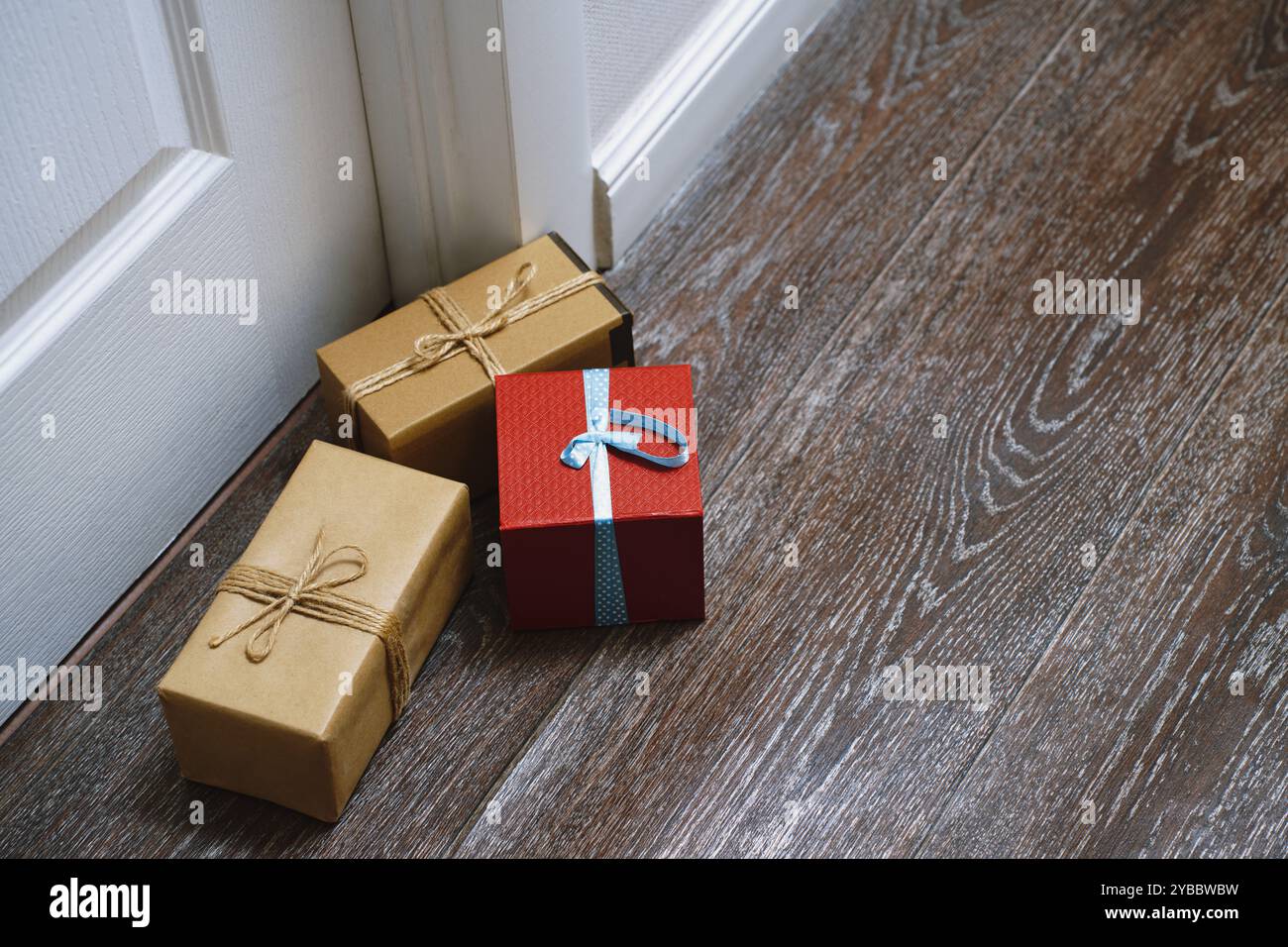 Gift boxes waiting next to the door Stock Photo - Alamy