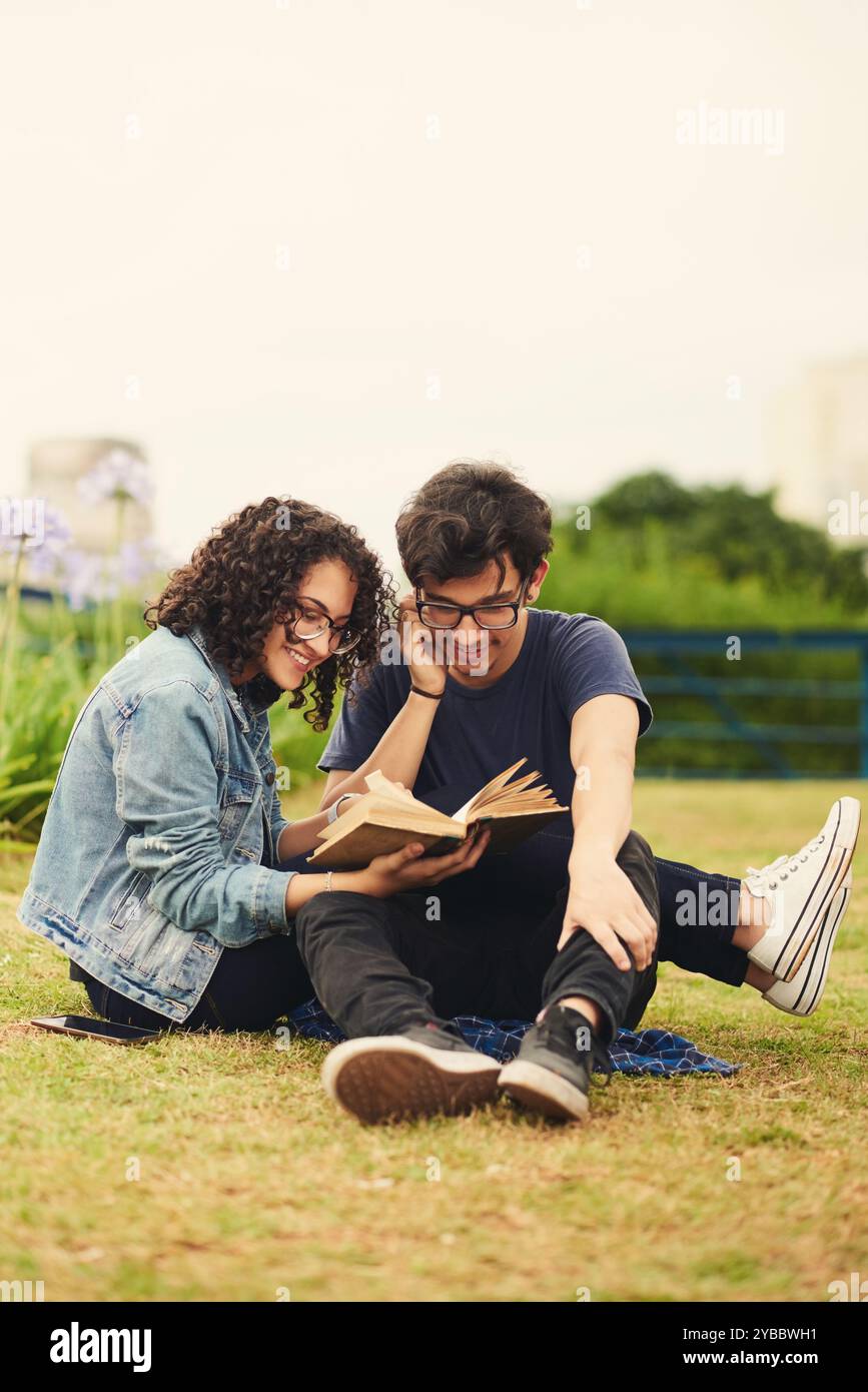 Couple, teenager and book outdoor for reading, bonding and relax ...