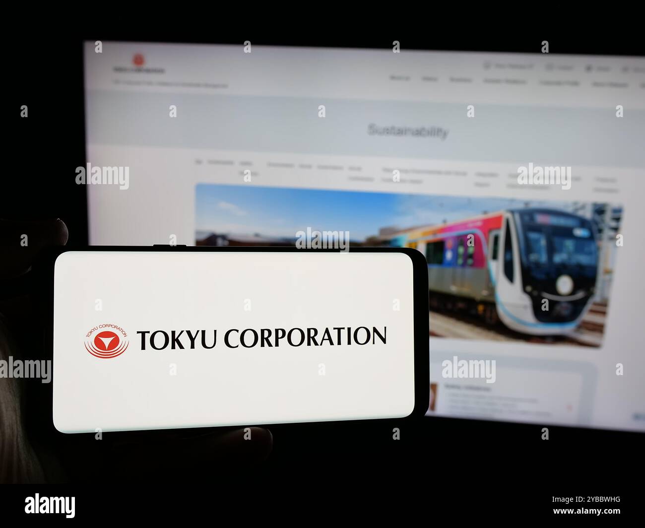 Person holding smartphone with logo of Japanese conglomerate company ...