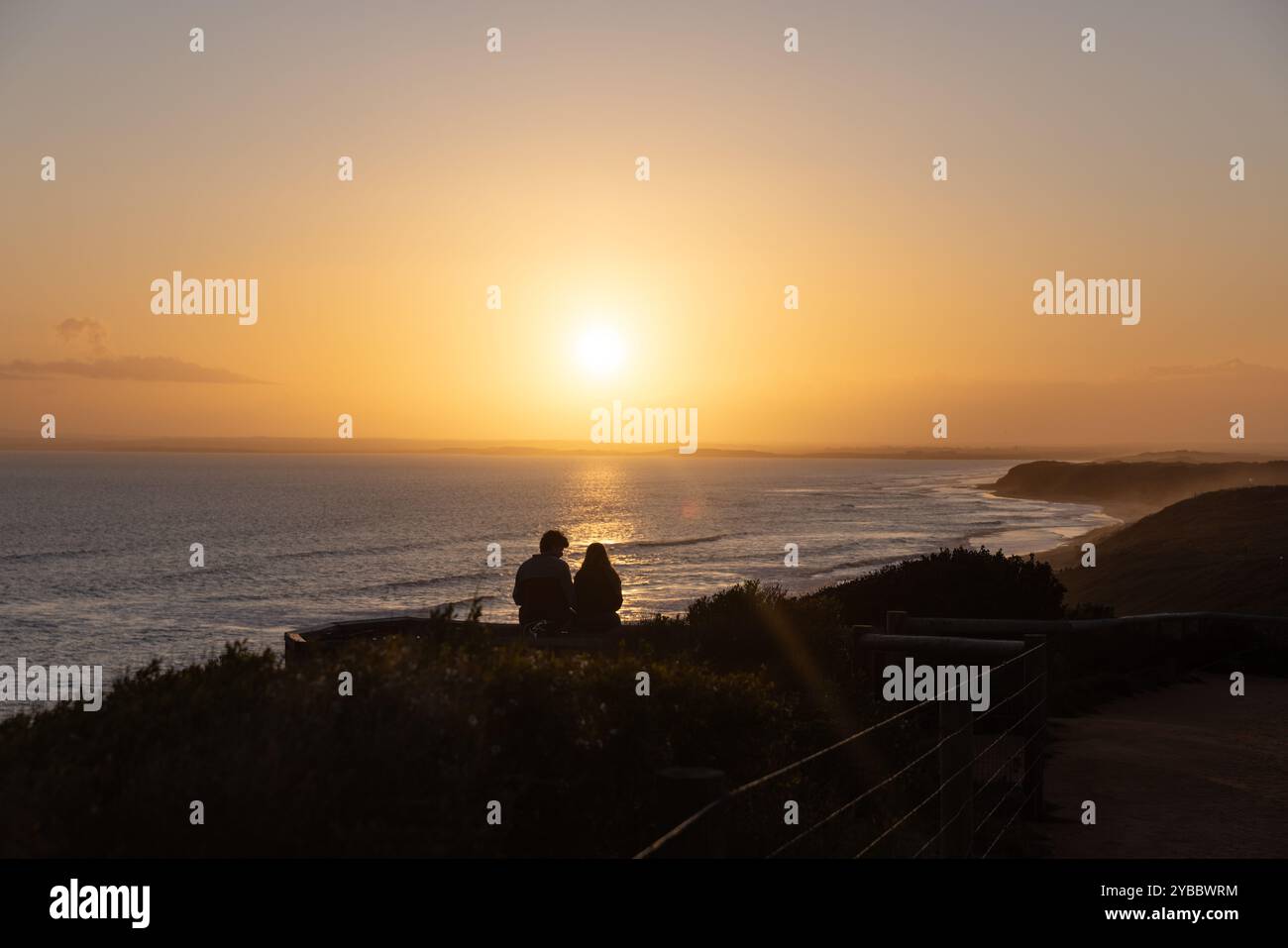 Couple watching sunset over ocean hi-res stock photography and images ...
