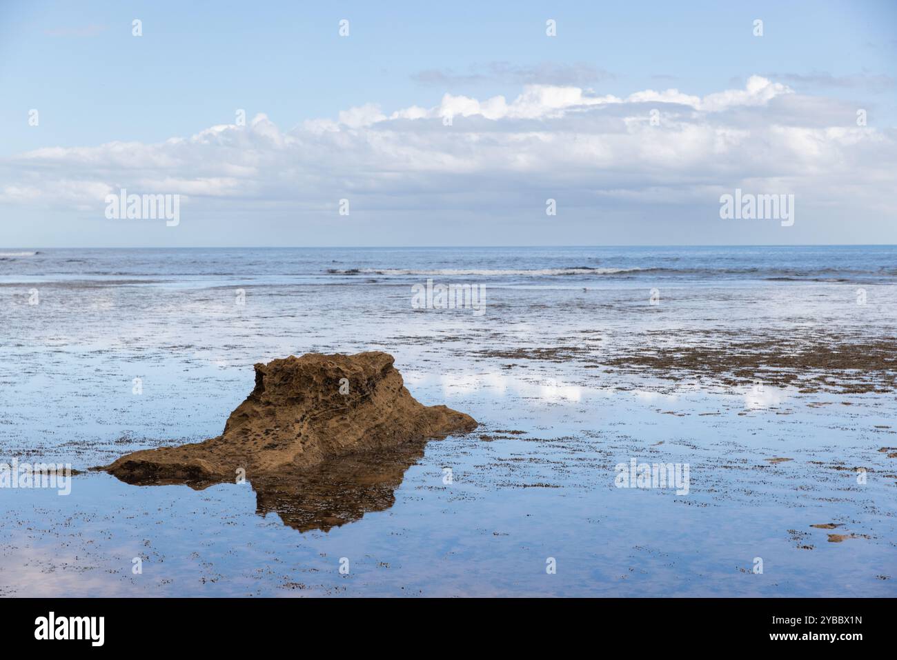 Rock formation and sky reflecting in shallow waters in Barwon Heads ...