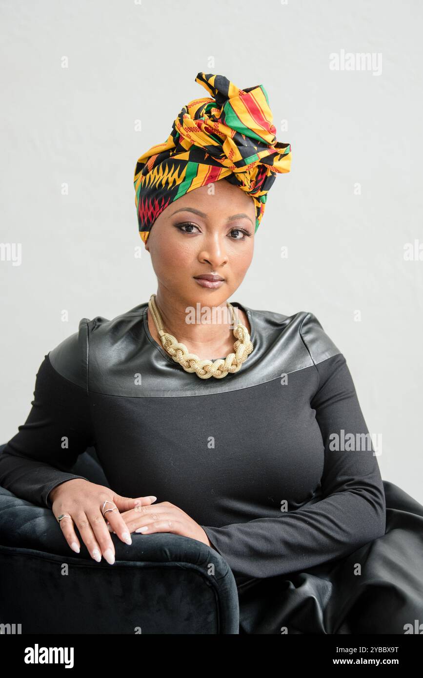 Nigerian Woman wearing a colorful head piece with black Stock Photo - Alamy