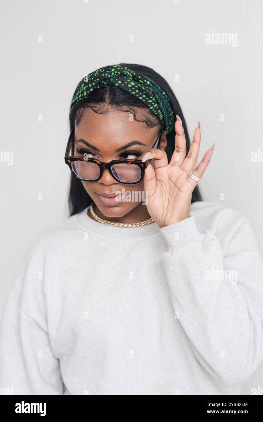 Woman looking over her glasses Stock Photo - Alamy