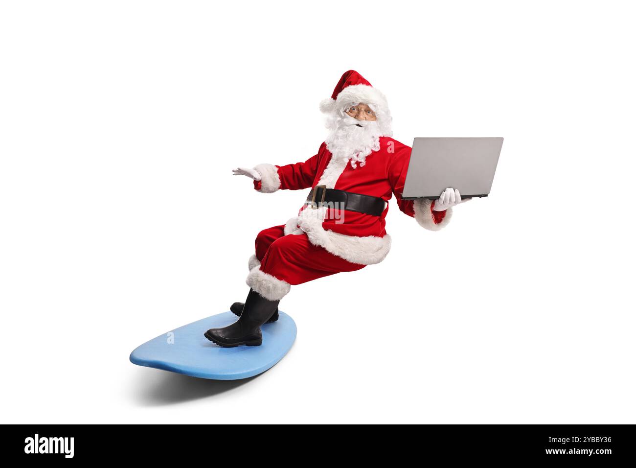 Santa claus riding a surfboard and holding a laptop computer isolated ...