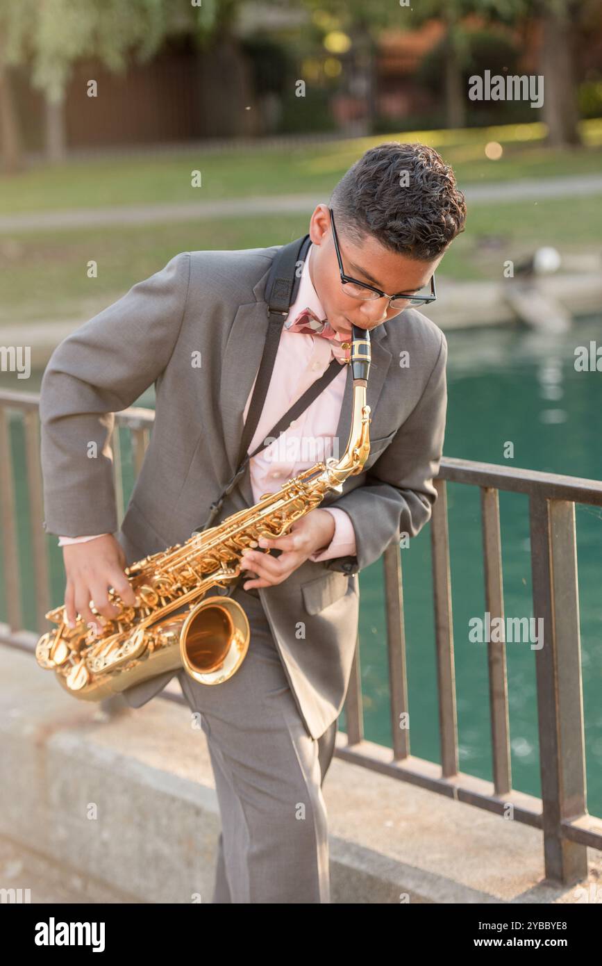Young boy playing the saxophone Stock Photo - Alamy