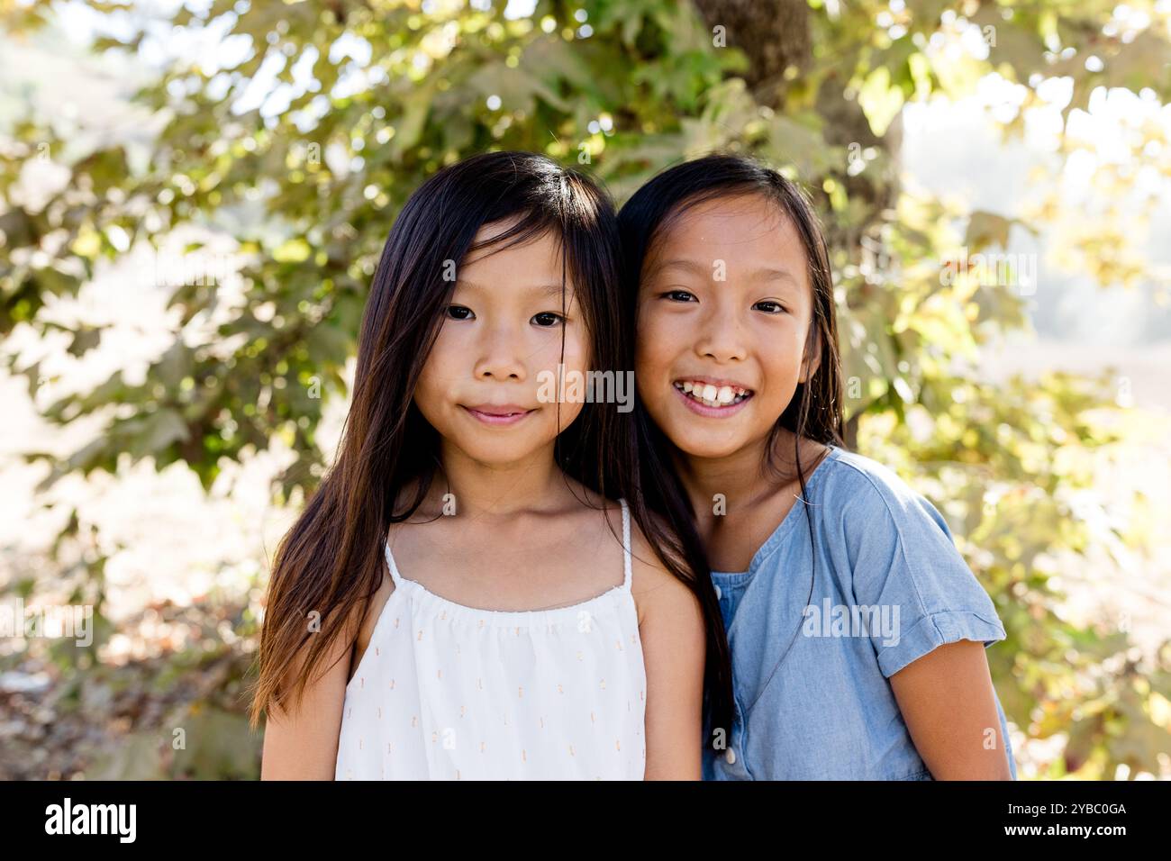 Sisters Smiling for Camera in San Diego Stock Photo - Alamy
