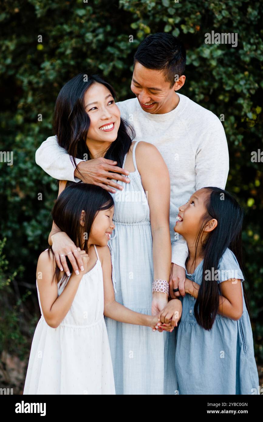 Cute Family of Four Hugging in Park in San Diego Stock Photo - Alamy
