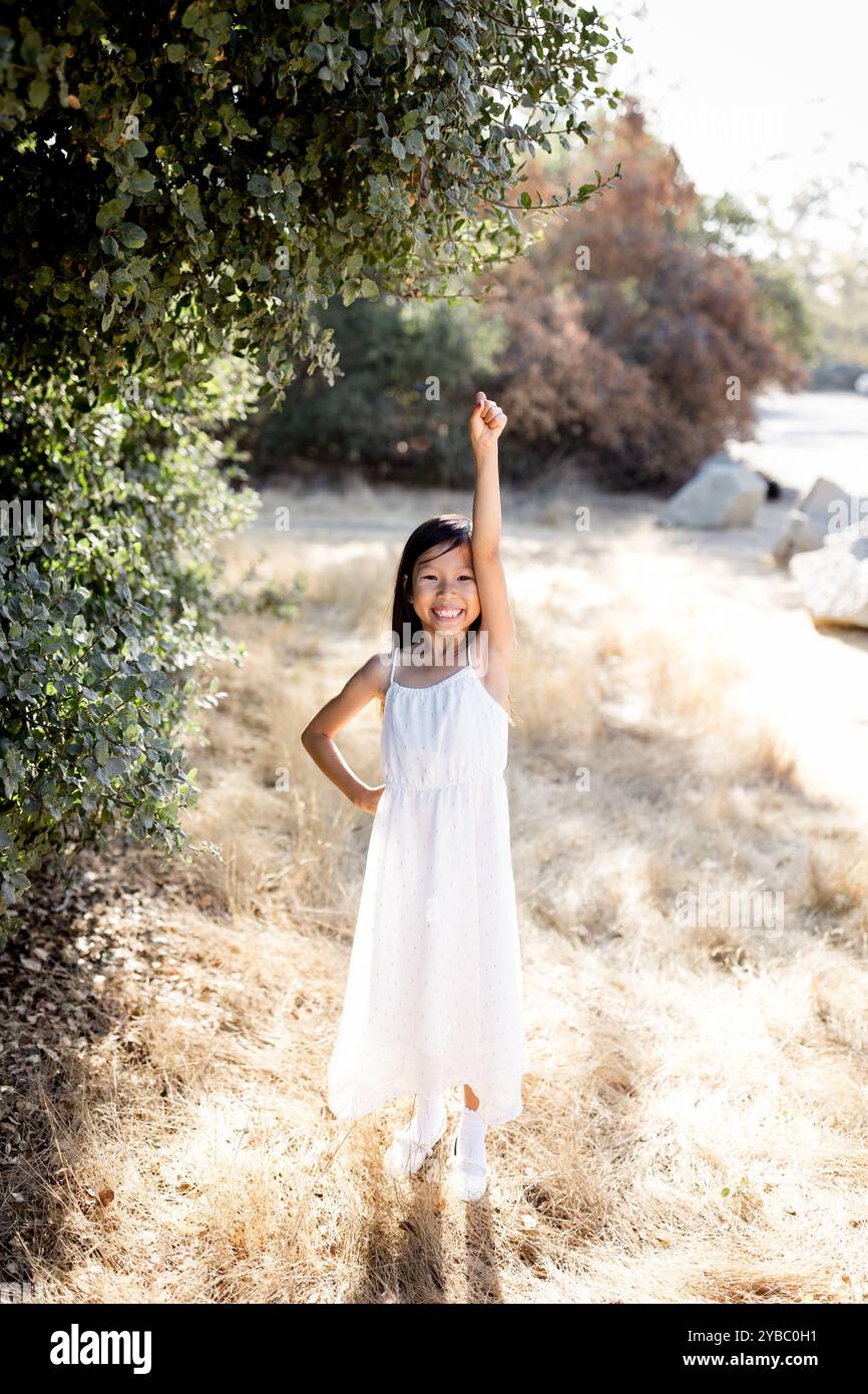 Seven Year Old Girl Standing with Arm in Air on Sunny Day in San Diego ...