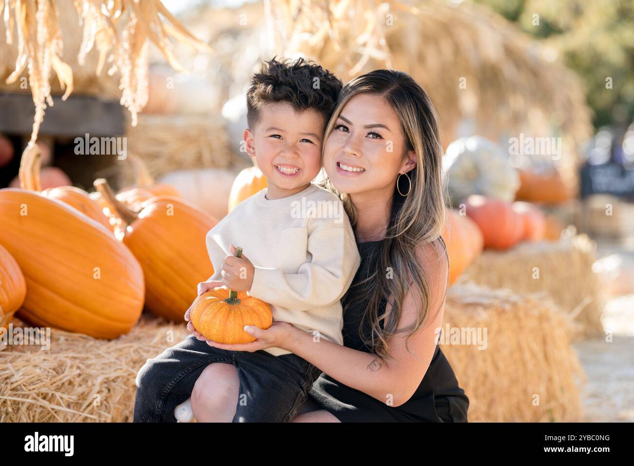 Little boy sitting on mothers lap and both are smiling Stock Photo - Alamy