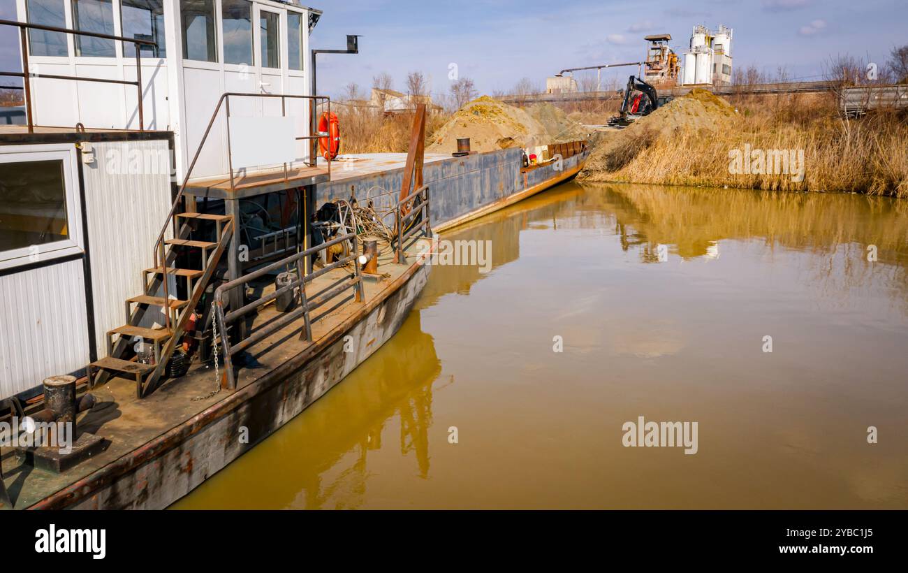 Above view over excavator, tow truck and tugboat as they pull out part ...