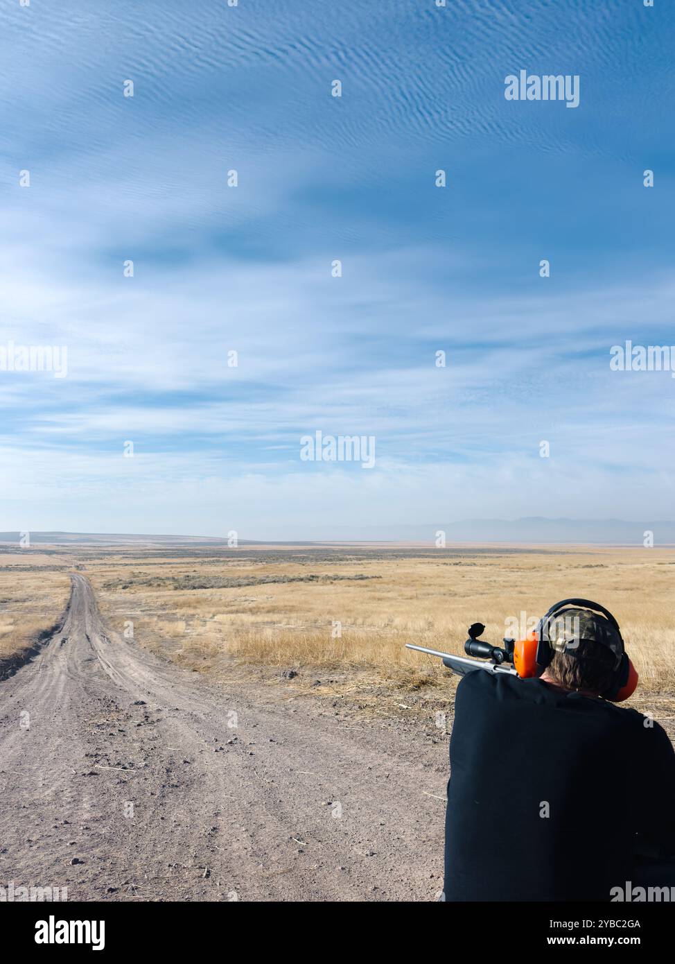 Man aiming rifle downrange at Boise shooting area Stock Photo - Alamy