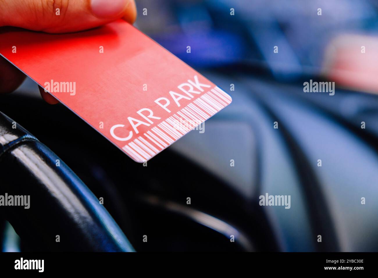 Driver is holding parking card getting ready to exit parking Stock Photo - Alamy