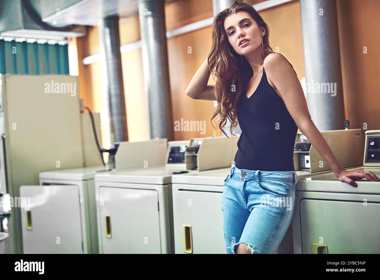 Portrait, relax and woman in laundry room, routine and chores with ...