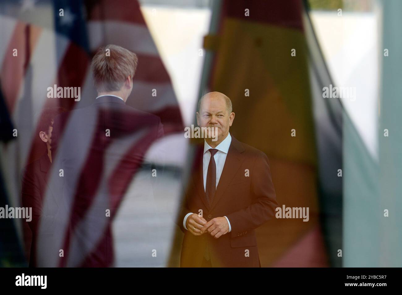 German Chancellor Olaf Scholz waits behind windows for US President Joe ...