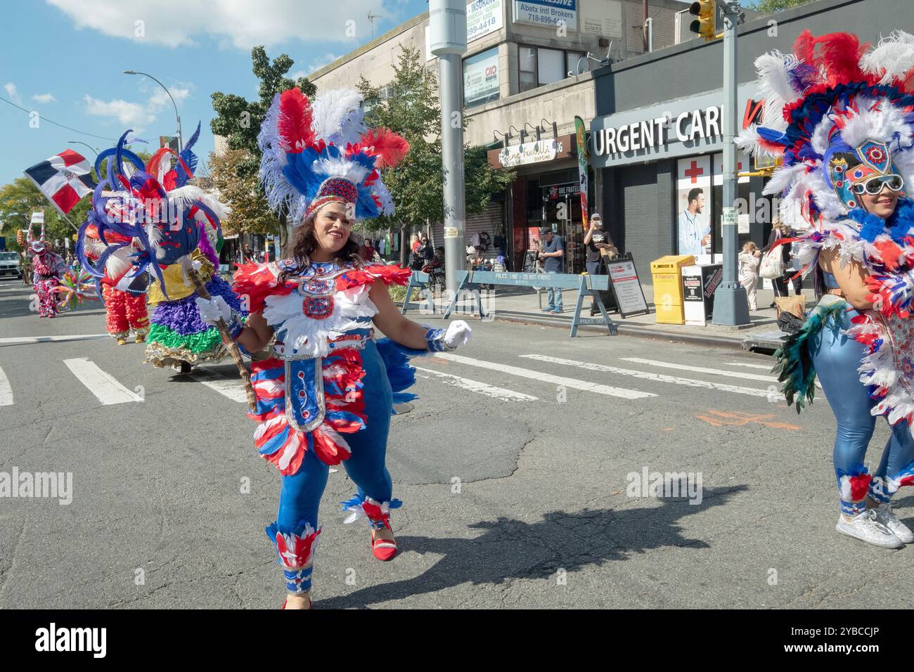 Women in colorful costumes march & dance in the 2024 Dominican Day ...