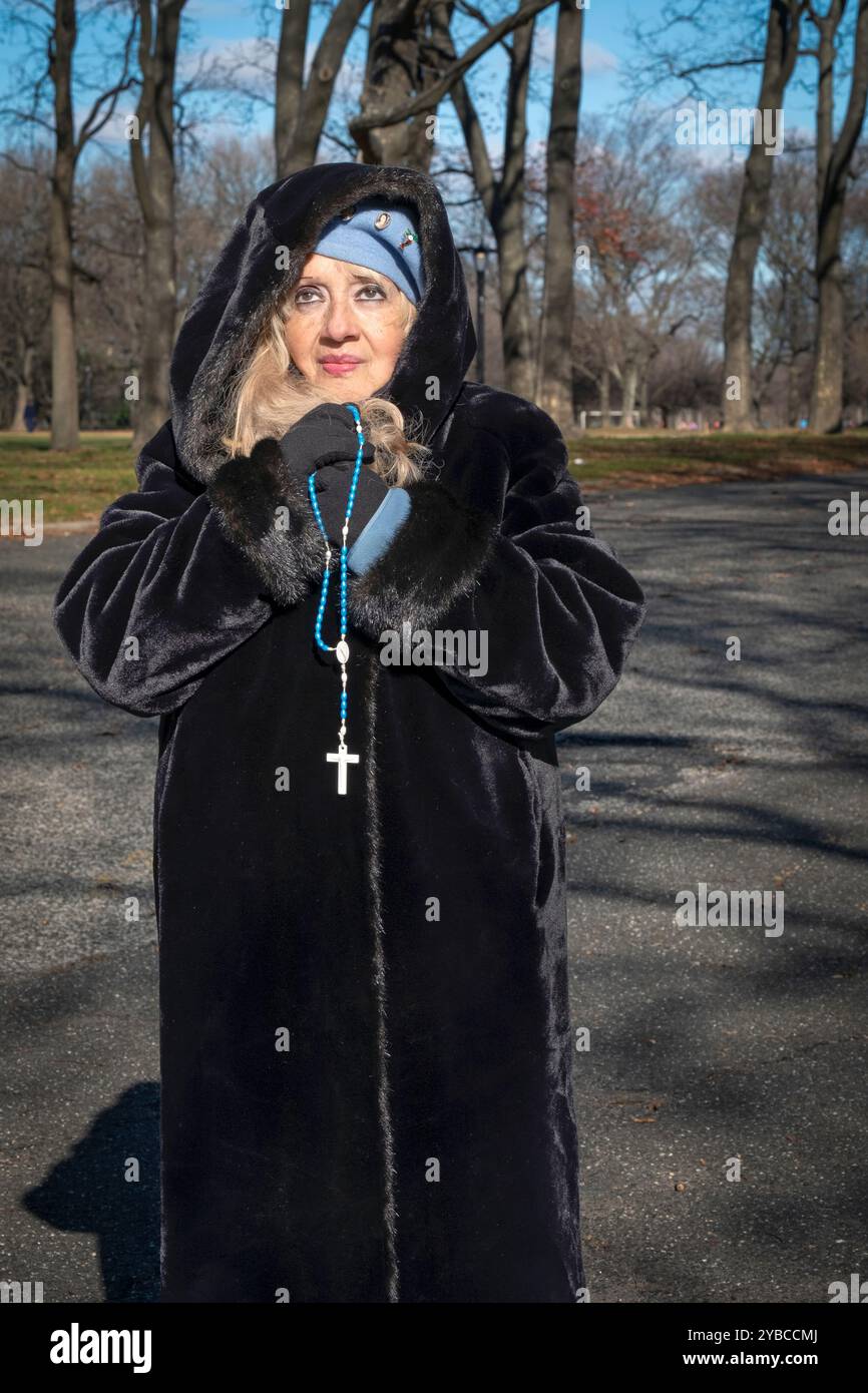 Devout Roman Catholic woman at a service the Vatican Pavilion site in ...