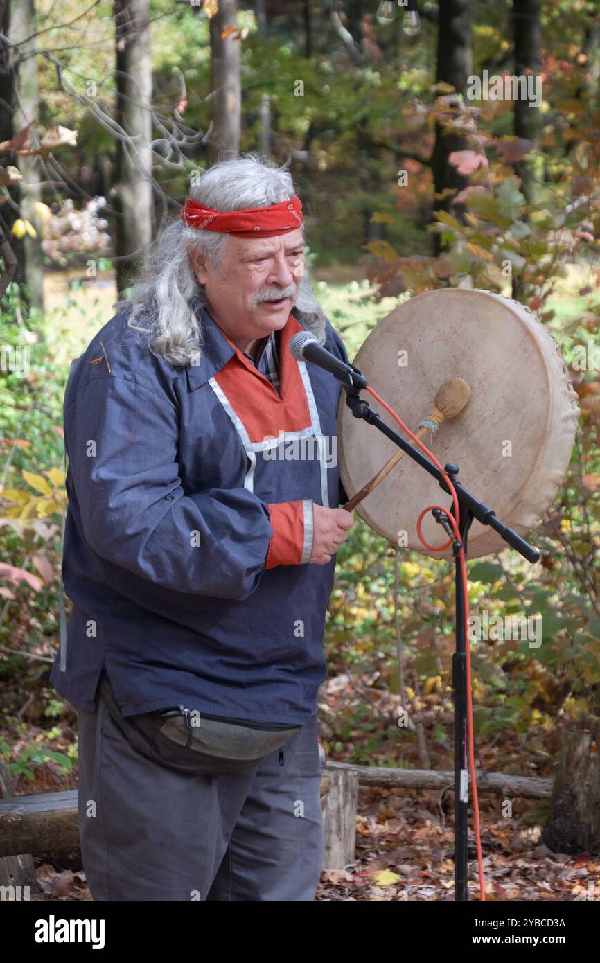 A member of the Munsee tribe plays a large Native American drum at an ...
