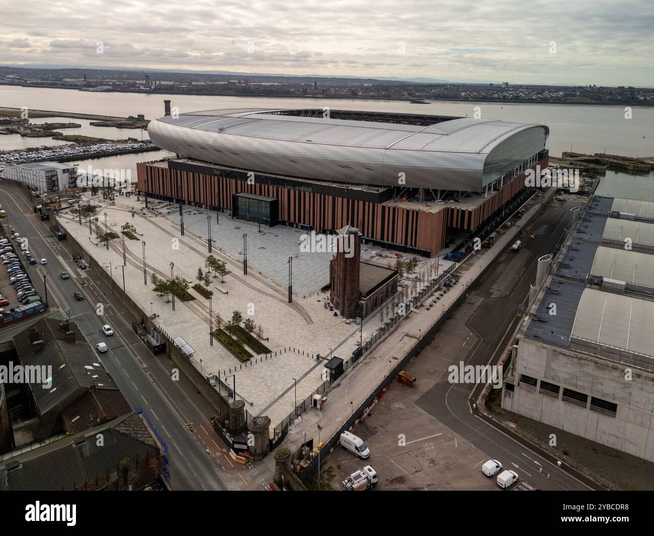 Aerial view showcasing a contemporary stadium situated by a serene ...