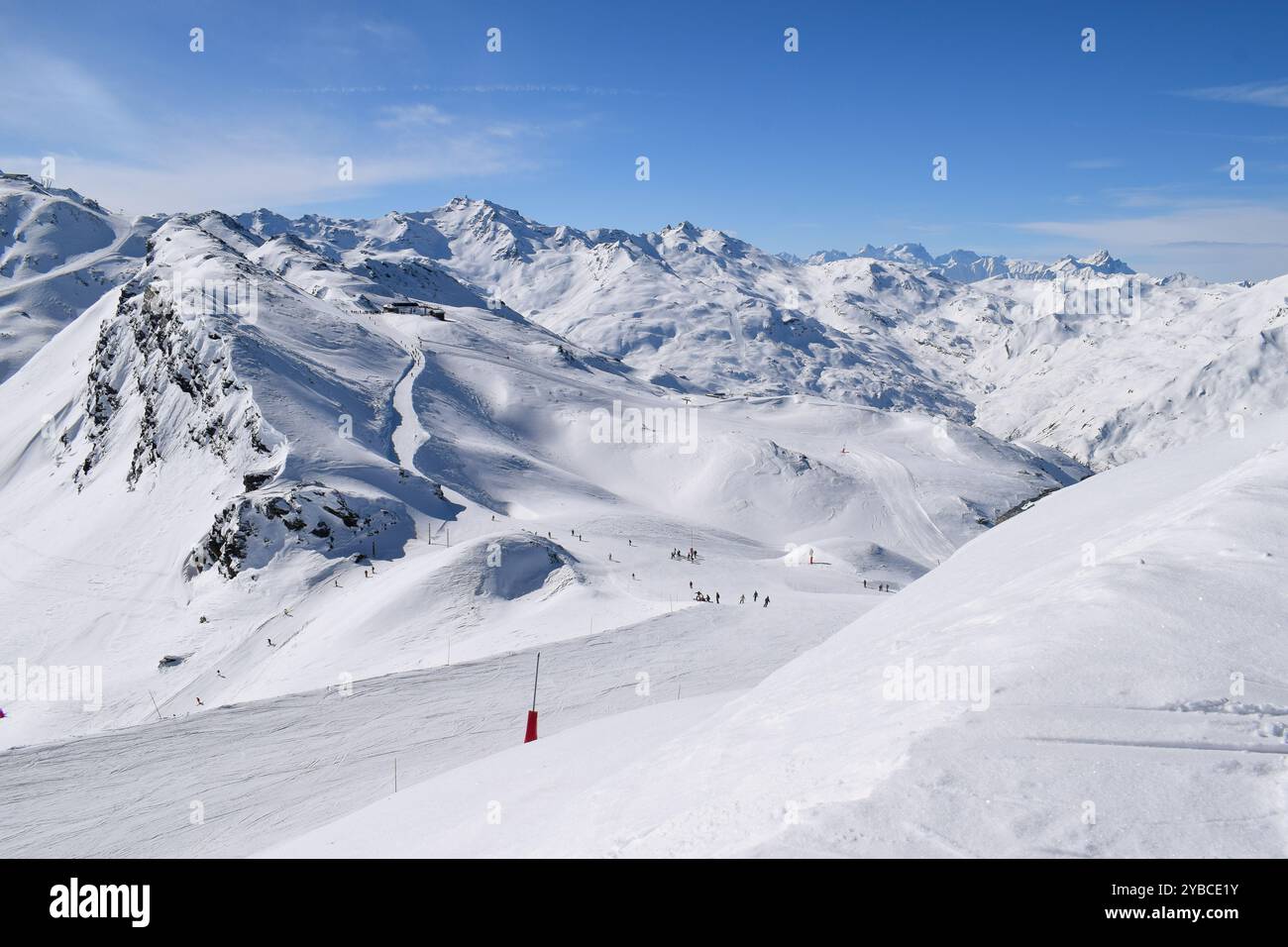 Skiers and snowboarders descending pistes in Les Menuires ski resort ...