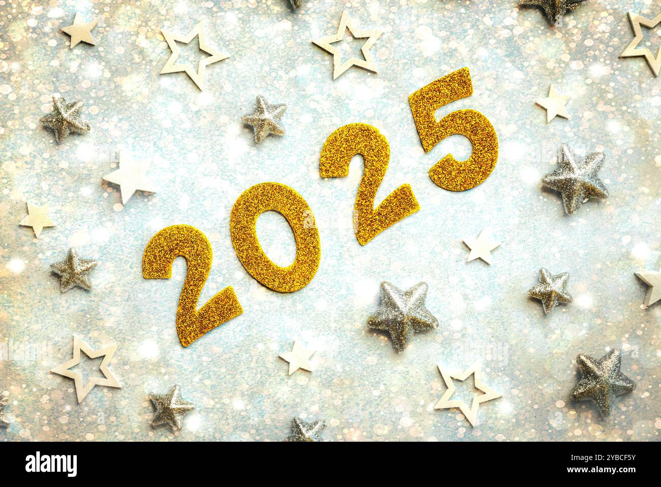 Happy new year 2025.Top view of golden letters of the number 2025 with white and silver stars on ...