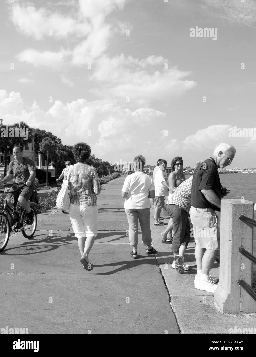 Group of tourists relaxing on the Battery, a historic landmark and ...