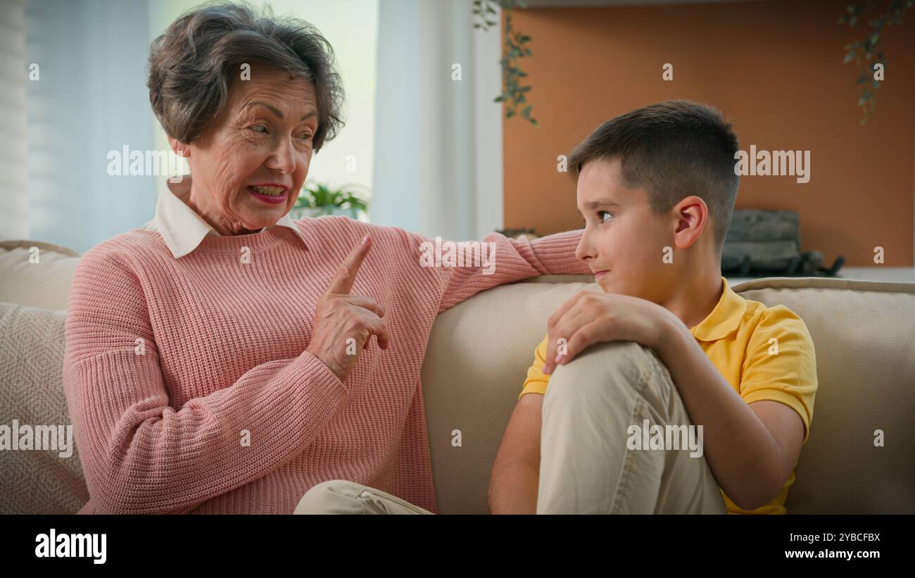 Caucasian grandmother explaining punishing spoiled grandson strict ...