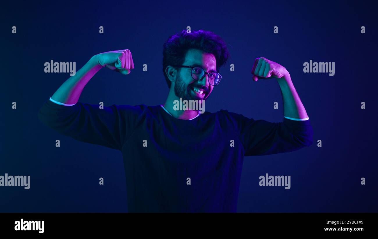 Funny Indian man slim guy fooling around show hands muscle biceps sport ...