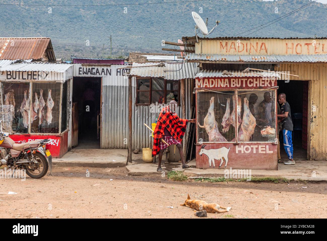 General street scene outside a butcher's shop with local customers ...