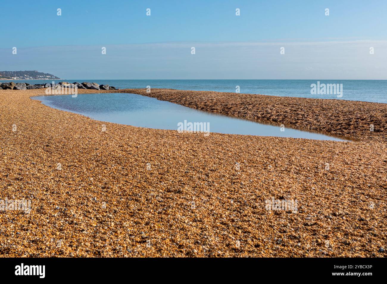 Calm water in a beach pool on the shingle beach in Hythe, Kent Stock ...