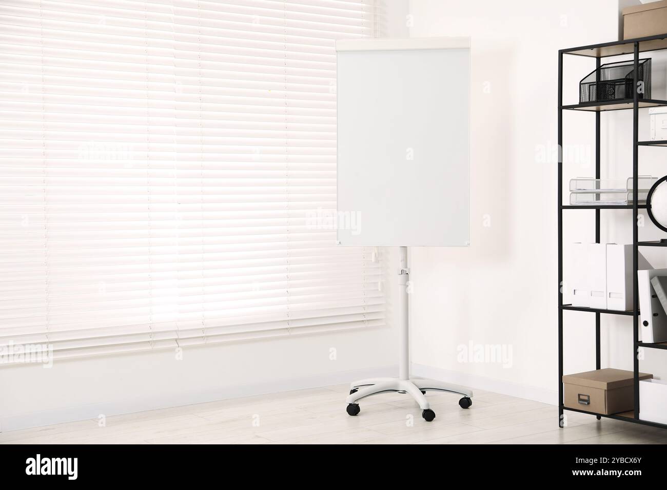 Flip chart near window in office. Mockup for design Stock Photo - Alamy