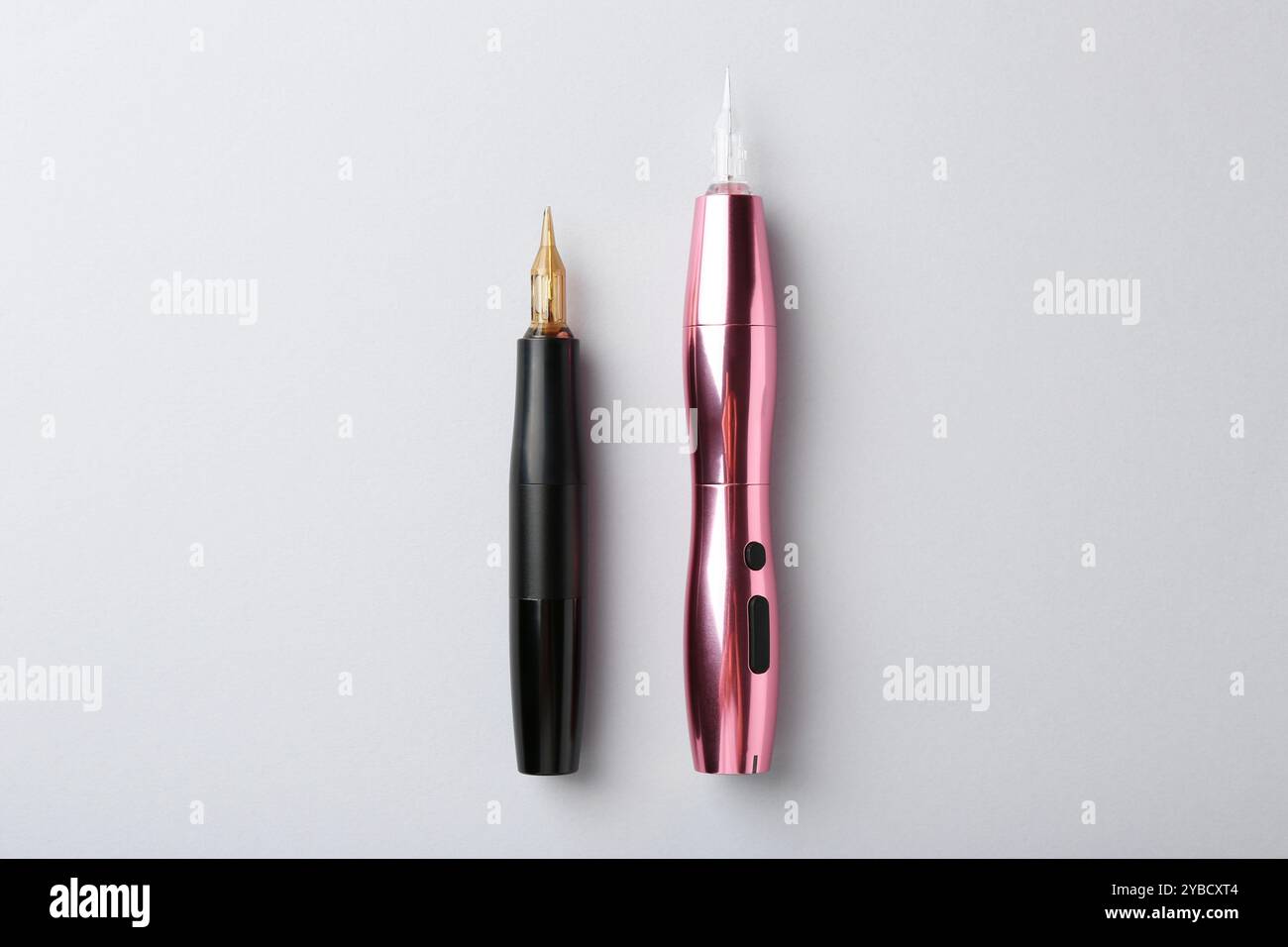 Professional permanent makeup machines on light grey background, top ...