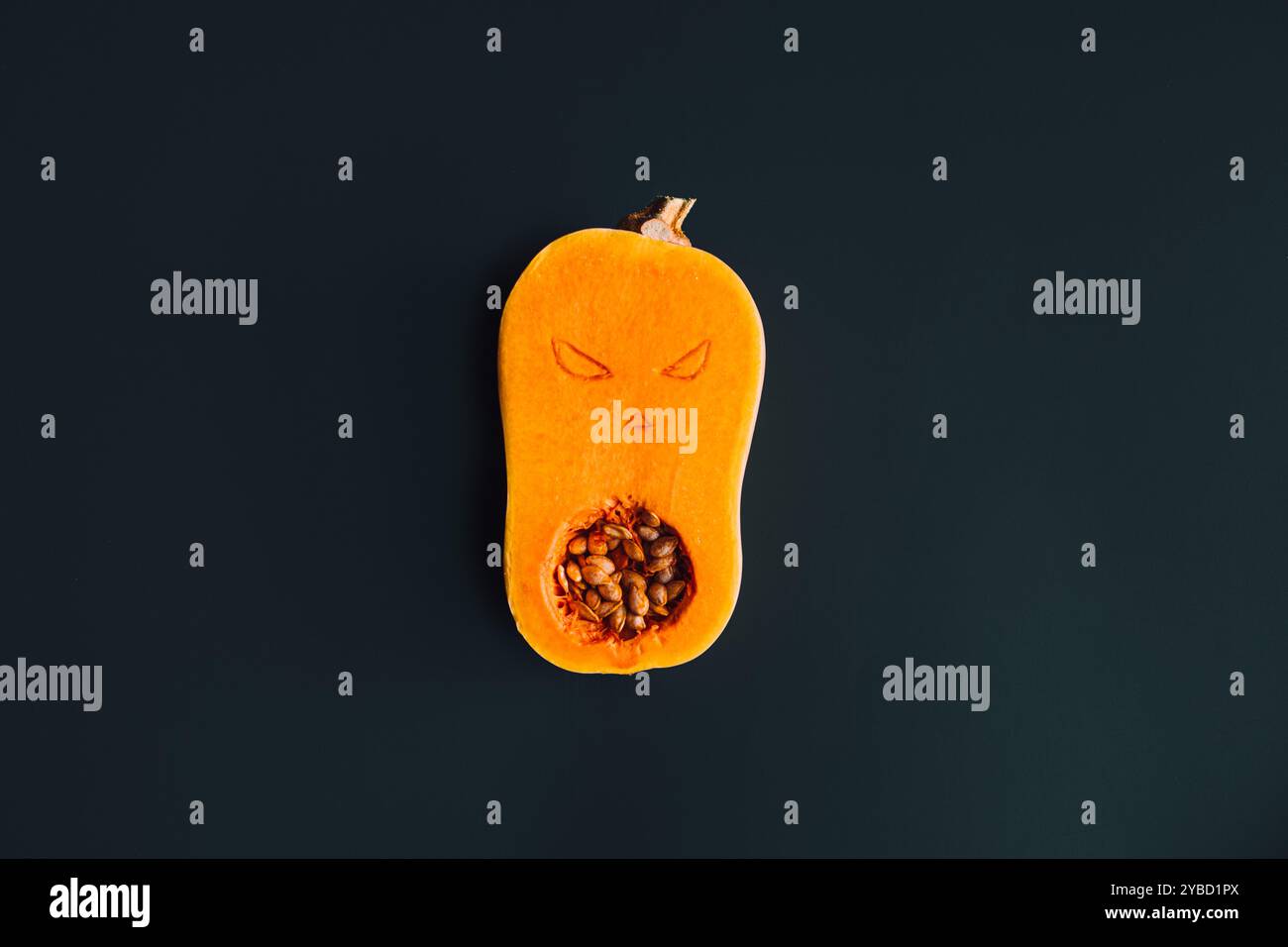 Butternut squash carved with spooky face, showcasing creative Halloween ...