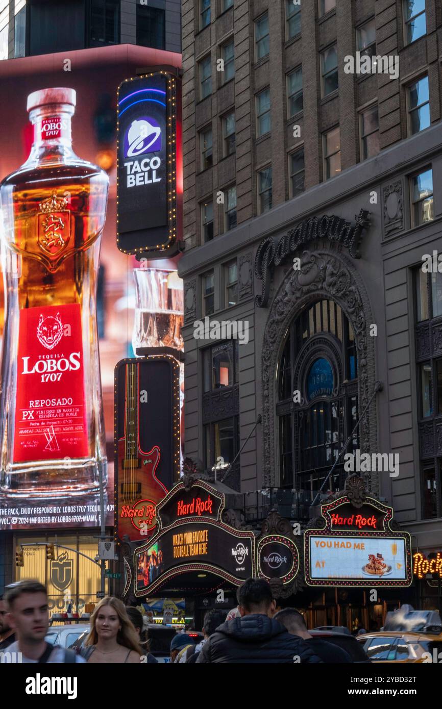 Street scene of Times Square includes restaurant signage and electronic ...