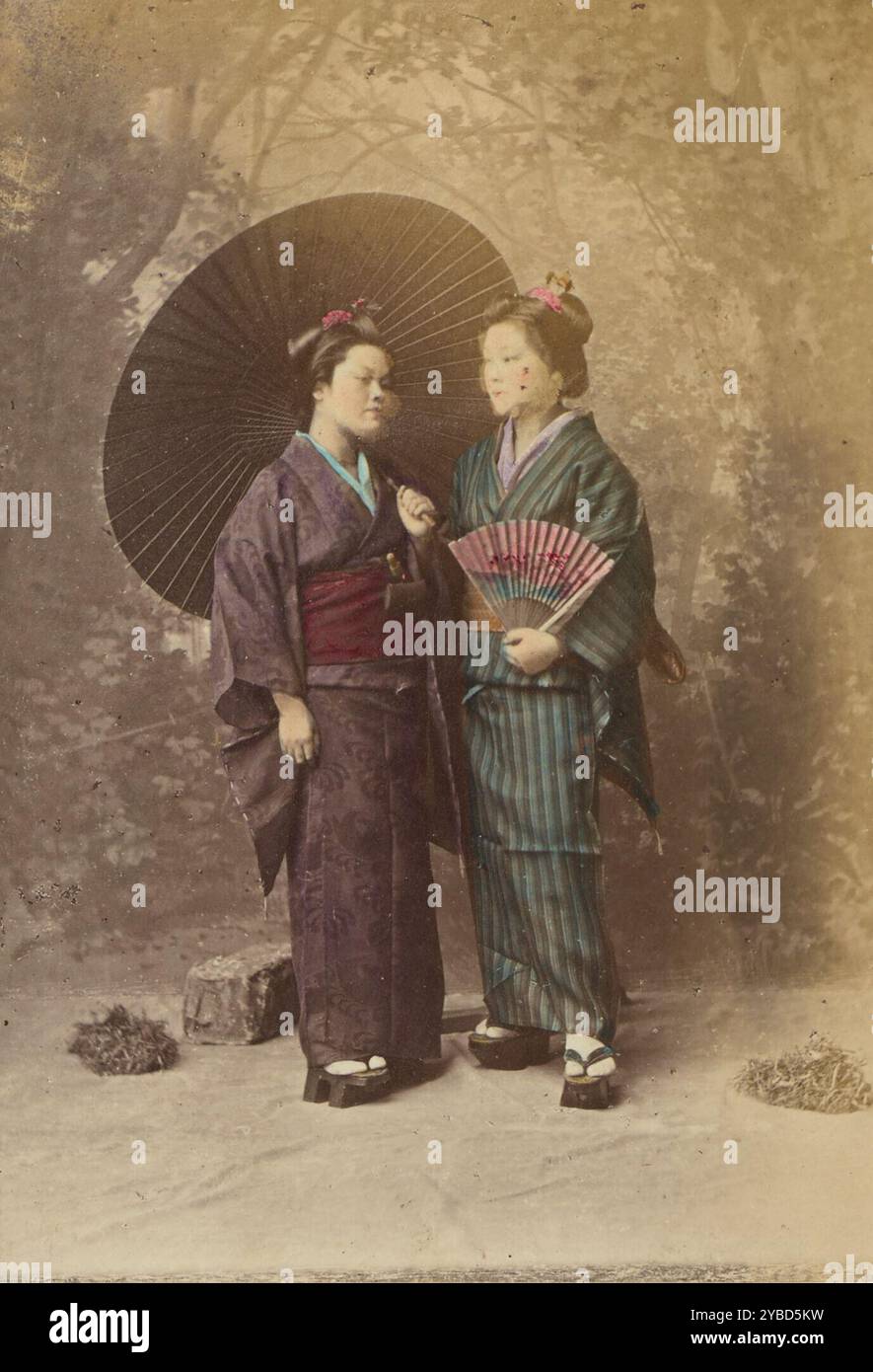 Two Japanese women, 1868-1880. Studio portrait of two women standing in ...