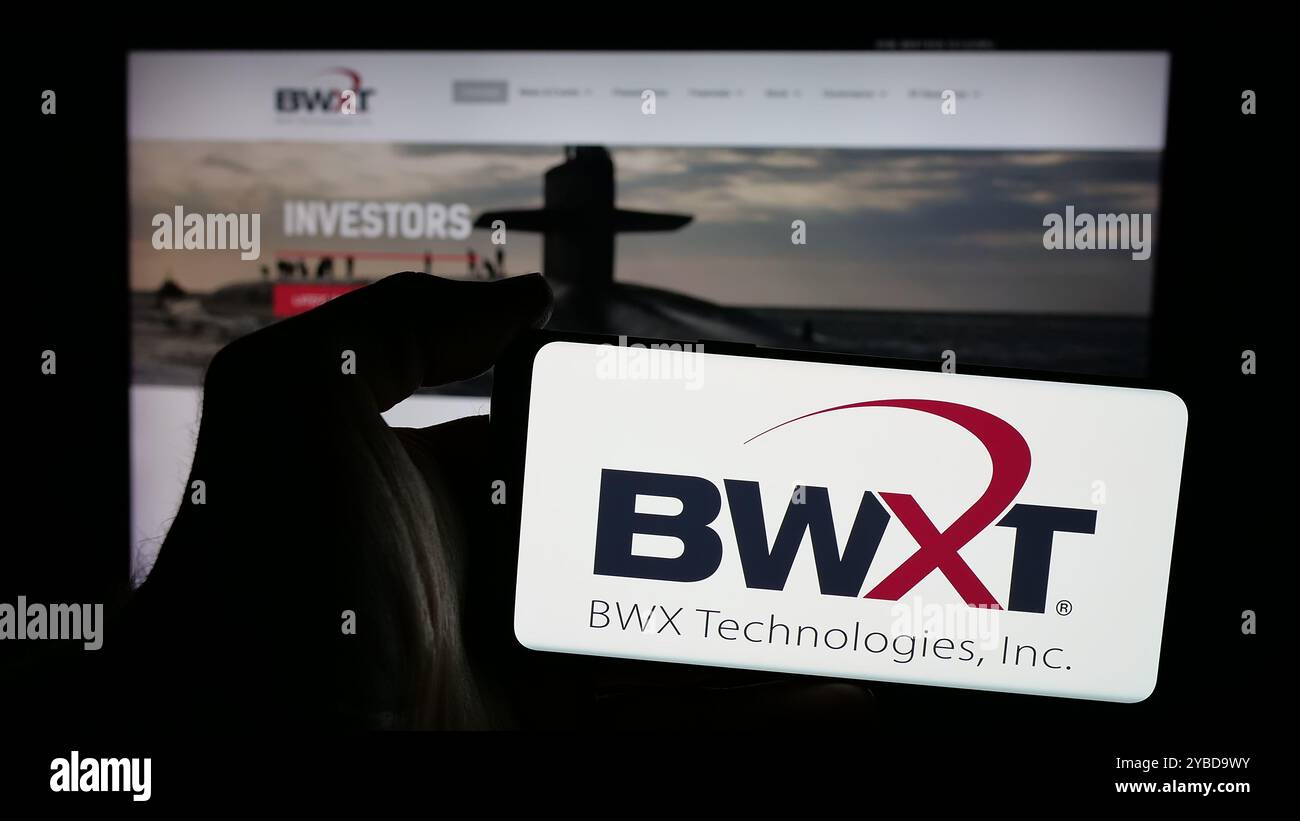 Person holding cellphone with logo of US nuclear company BWX ...