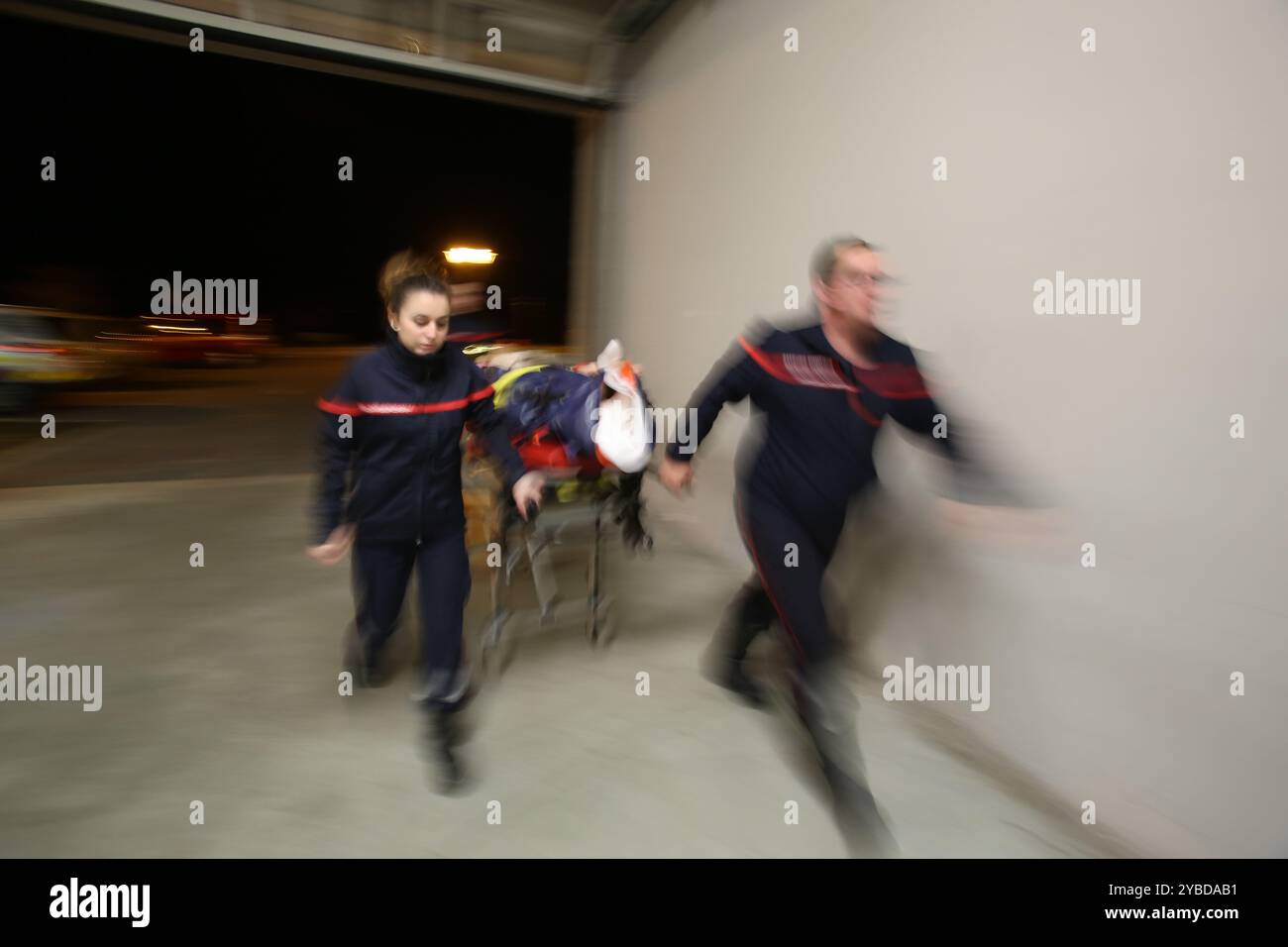 Manosque, France. 24 December 2019. Ambulance paramedics rush into ...