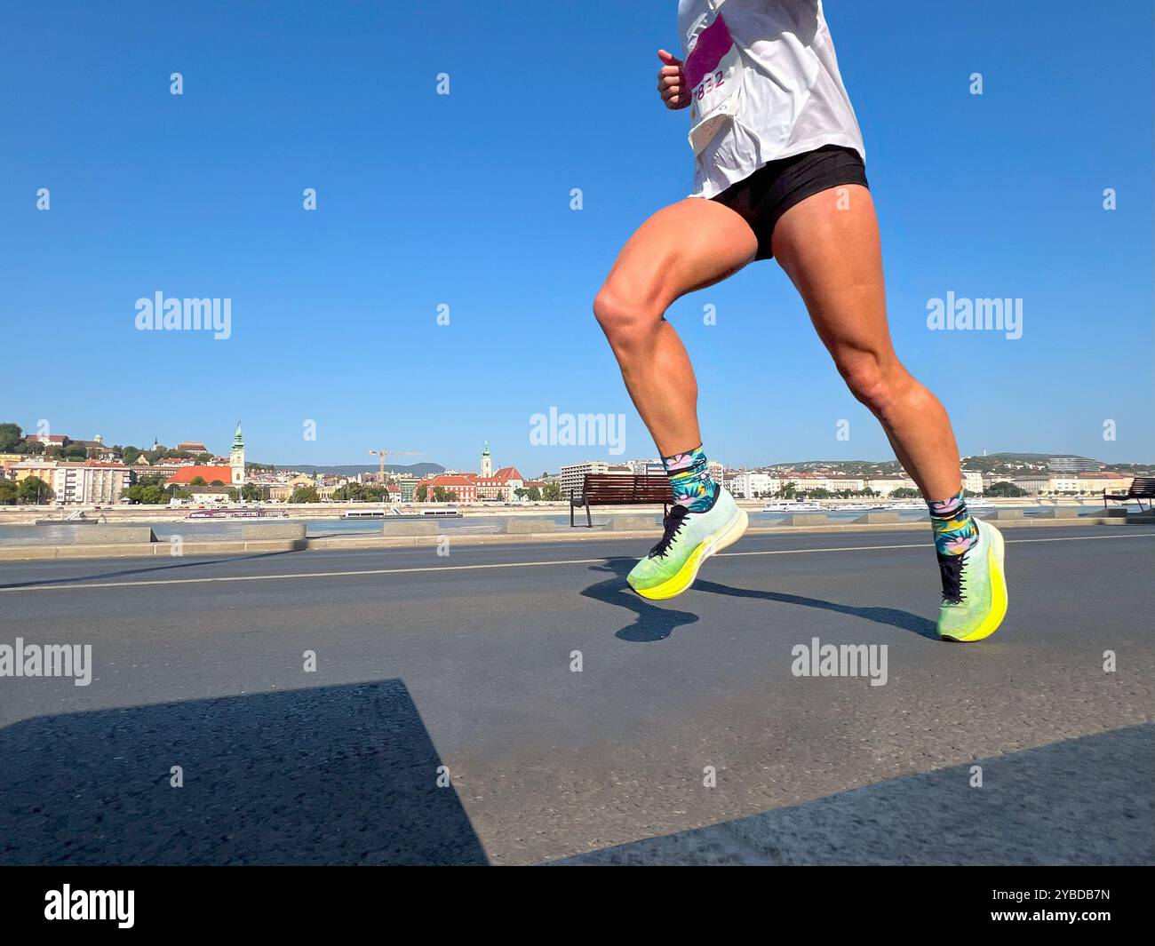 legs woman athlete running marathon in embankment river Stock Photo - Alamy