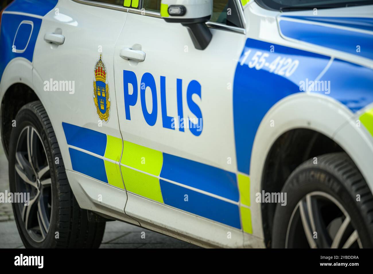 A police car is stationed on an urban street, showcasing its vibrant ...