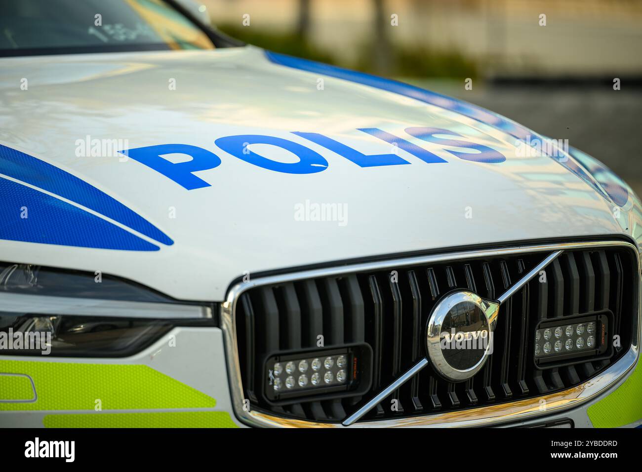 A police vehicle is parked in a busy urban area, clearly displaying its ...