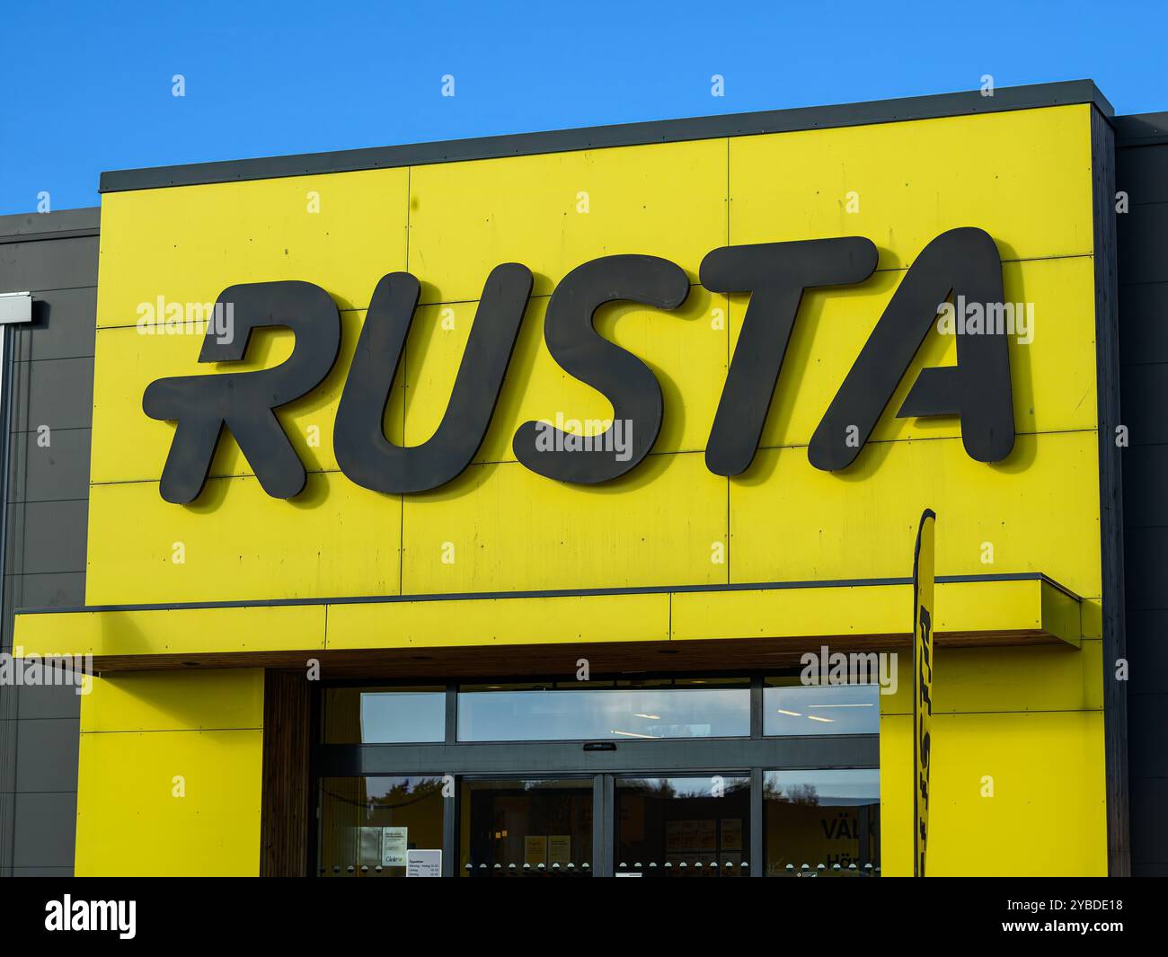 The exterior of a retail store features large, bold signage with the ...