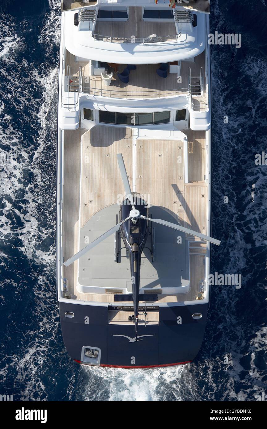 Helicopter landing on the helideck of superyacht T6 while moving at sea ...