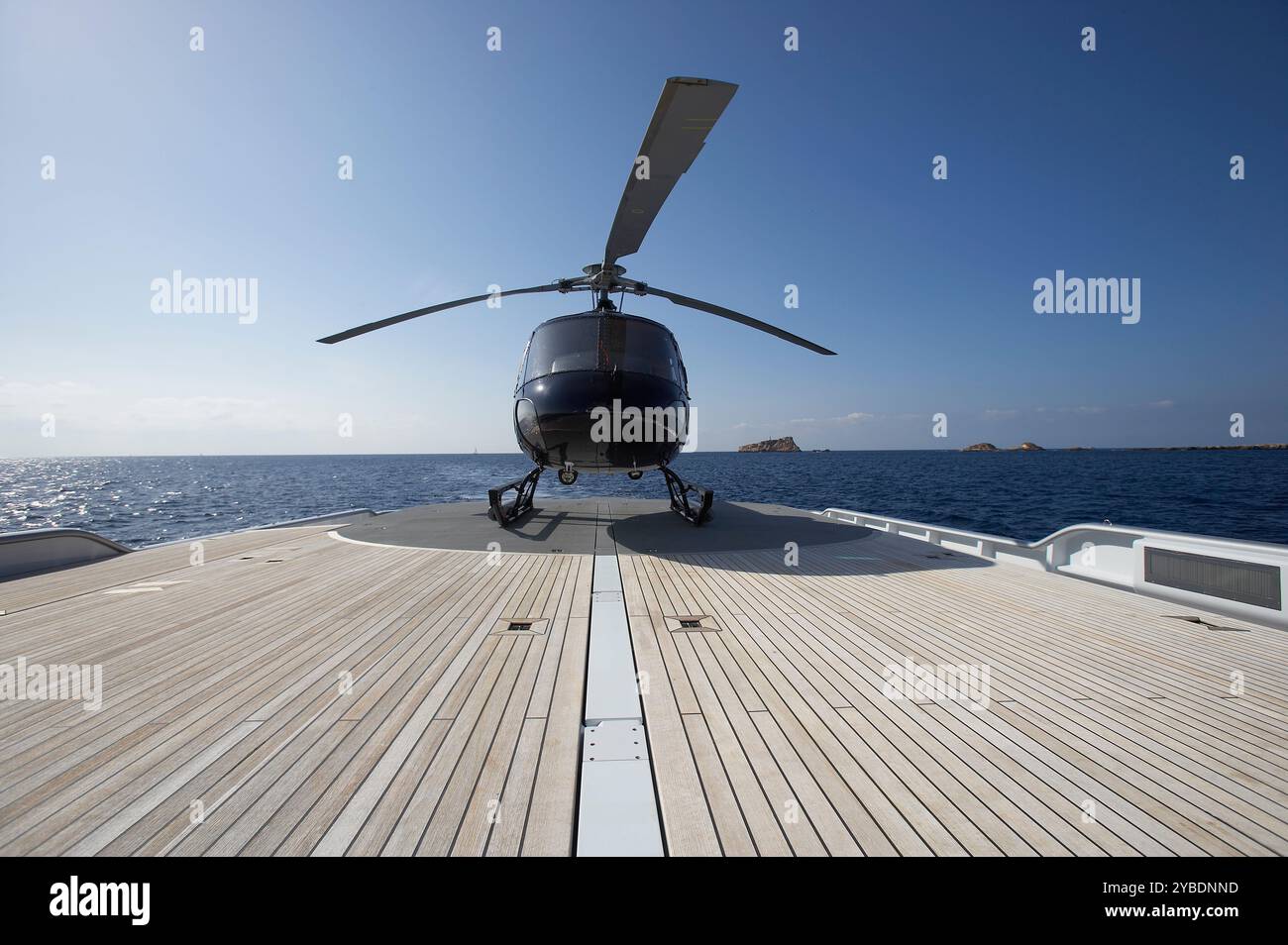 Helicopter landing on the helideck of superyacht T6 while moving at sea ...