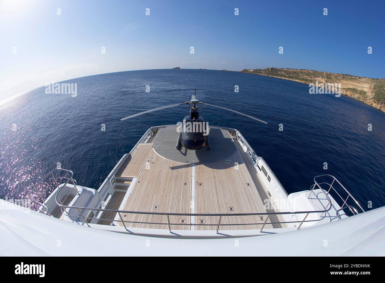 Helicopter landing on the helideck of superyacht T6 while moving at sea ...