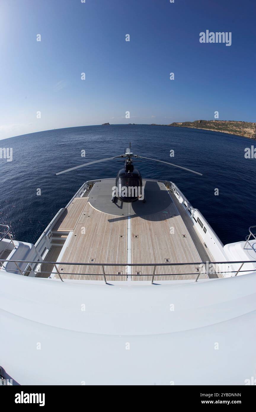 Helicopter landing on the helideck of superyacht T6 while moving at sea ...