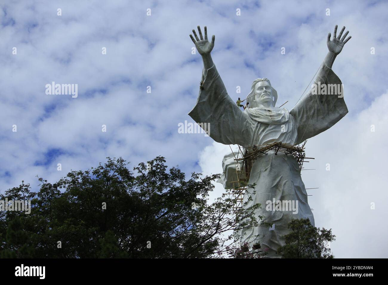 Workers take care of one of Manado popular landmarks, the giant Jesus ...