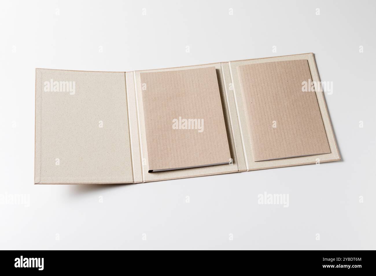 Coupled cardboard folder, open and with two notepads glued inside with ...