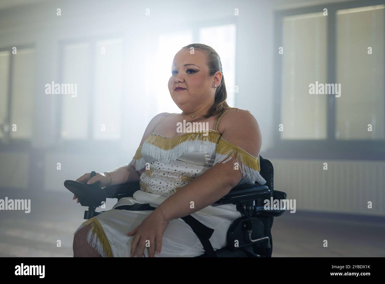 Confident pretty young woman with a disability, on her electric ...