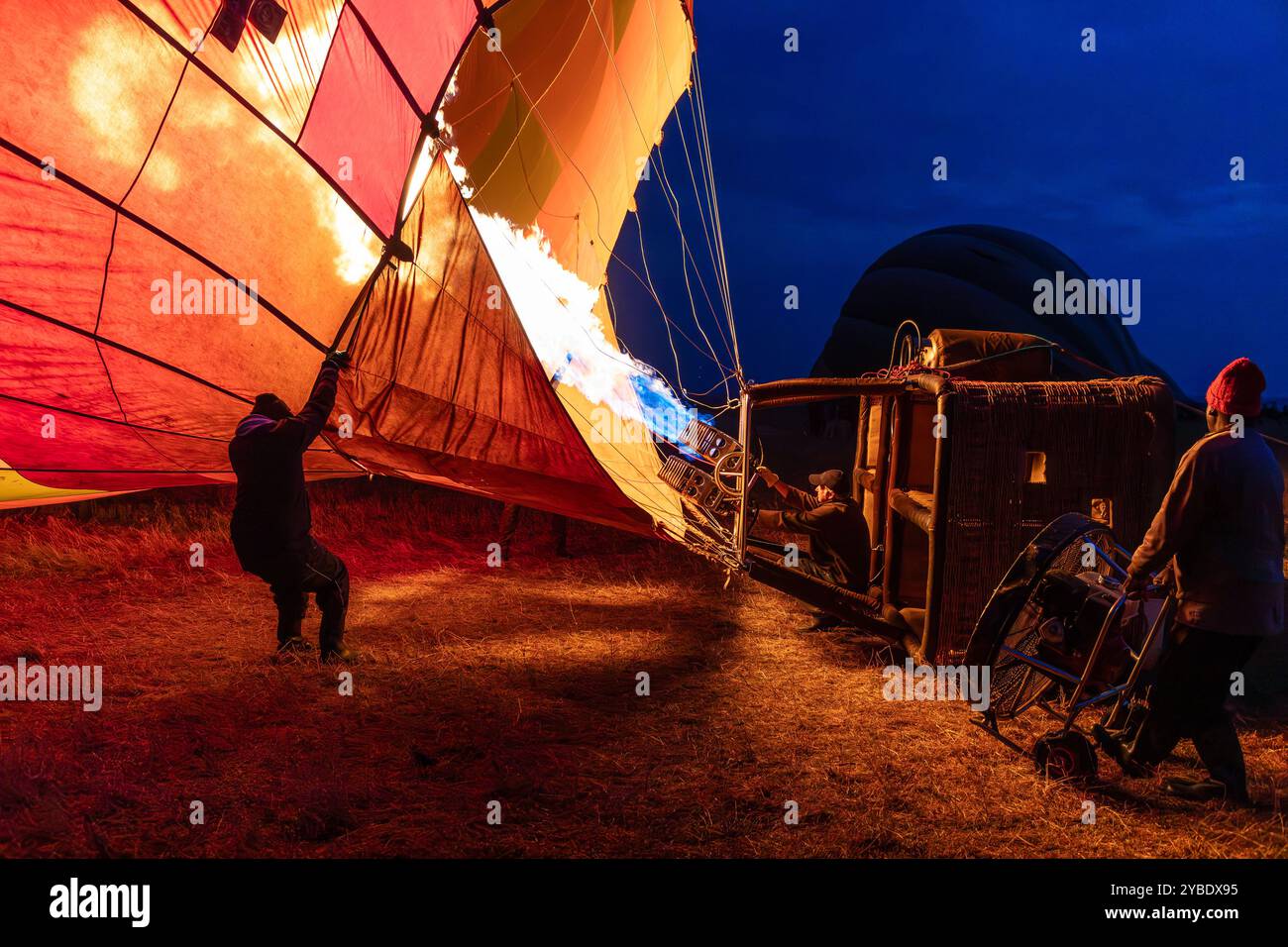 Ariel balloon being inflated before a dawn flight above the Masai Mara ...
