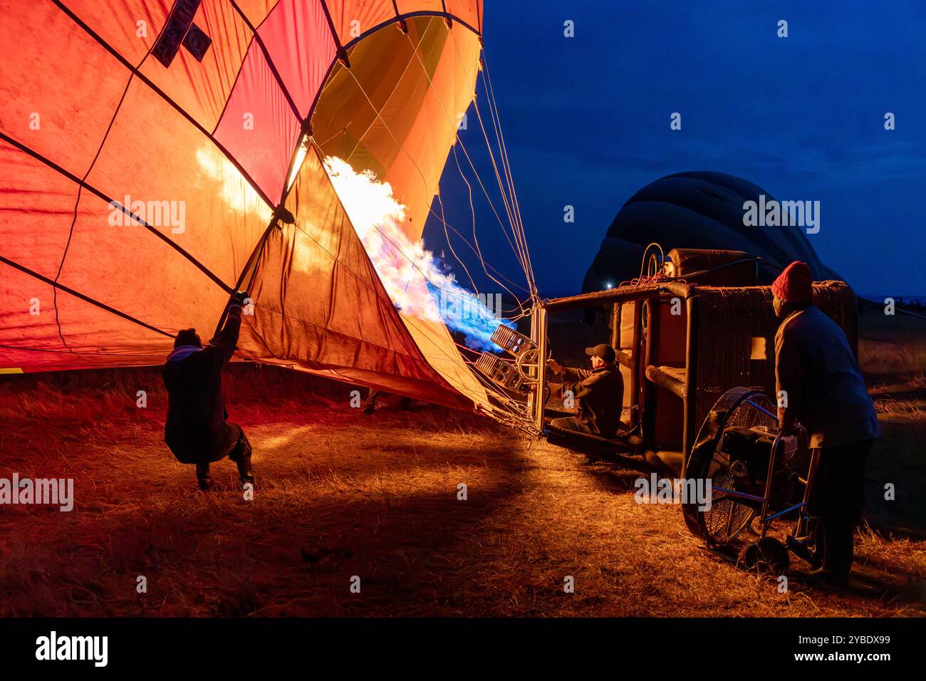 Ariel balloon being inflated before a dawn flight above the Masai Mara ...